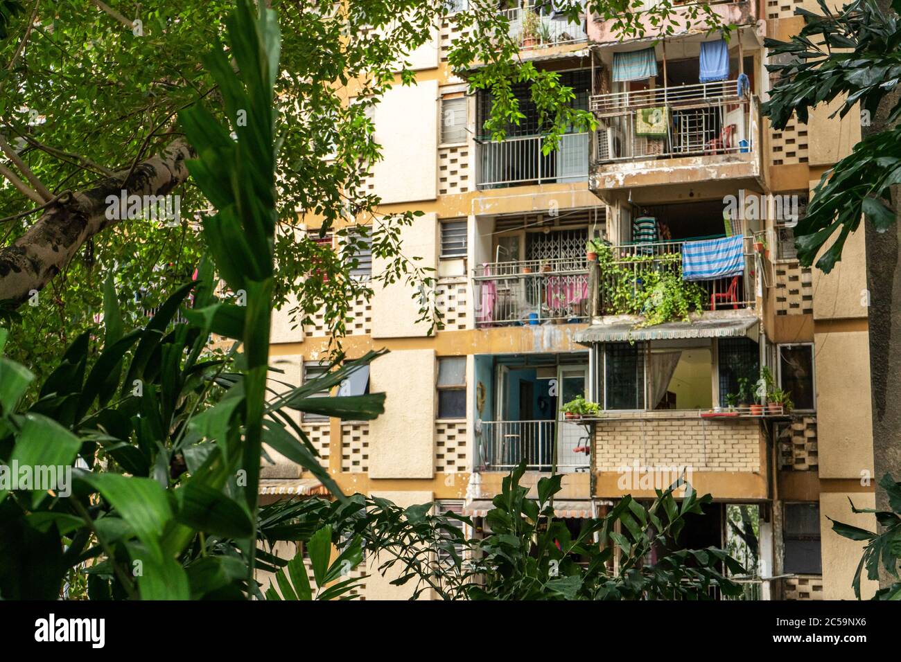 The balconies of an apartment building are hung with clothes. The poor ...