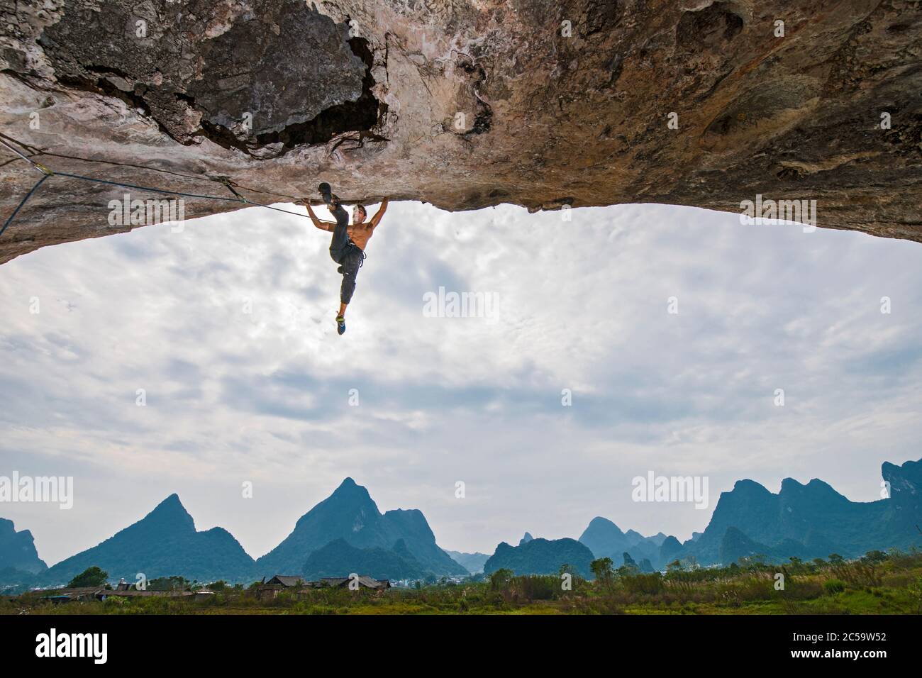 Man climbing steep overhang in Yangshuo / China Stock Photo - Alamy