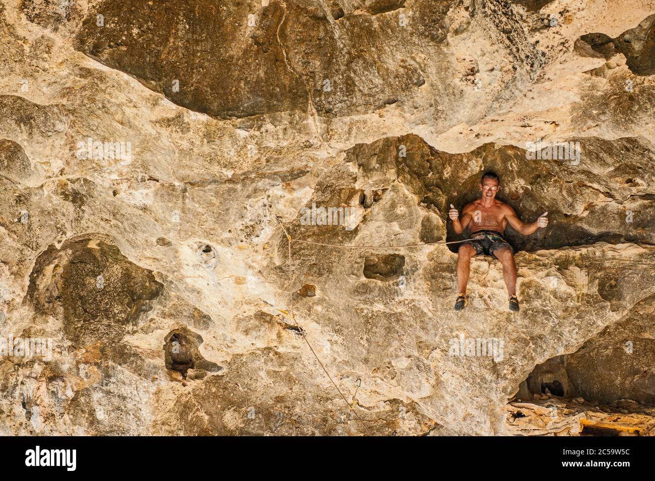 Man sitting on rock ledge hi-res stock photography and images - Alamy