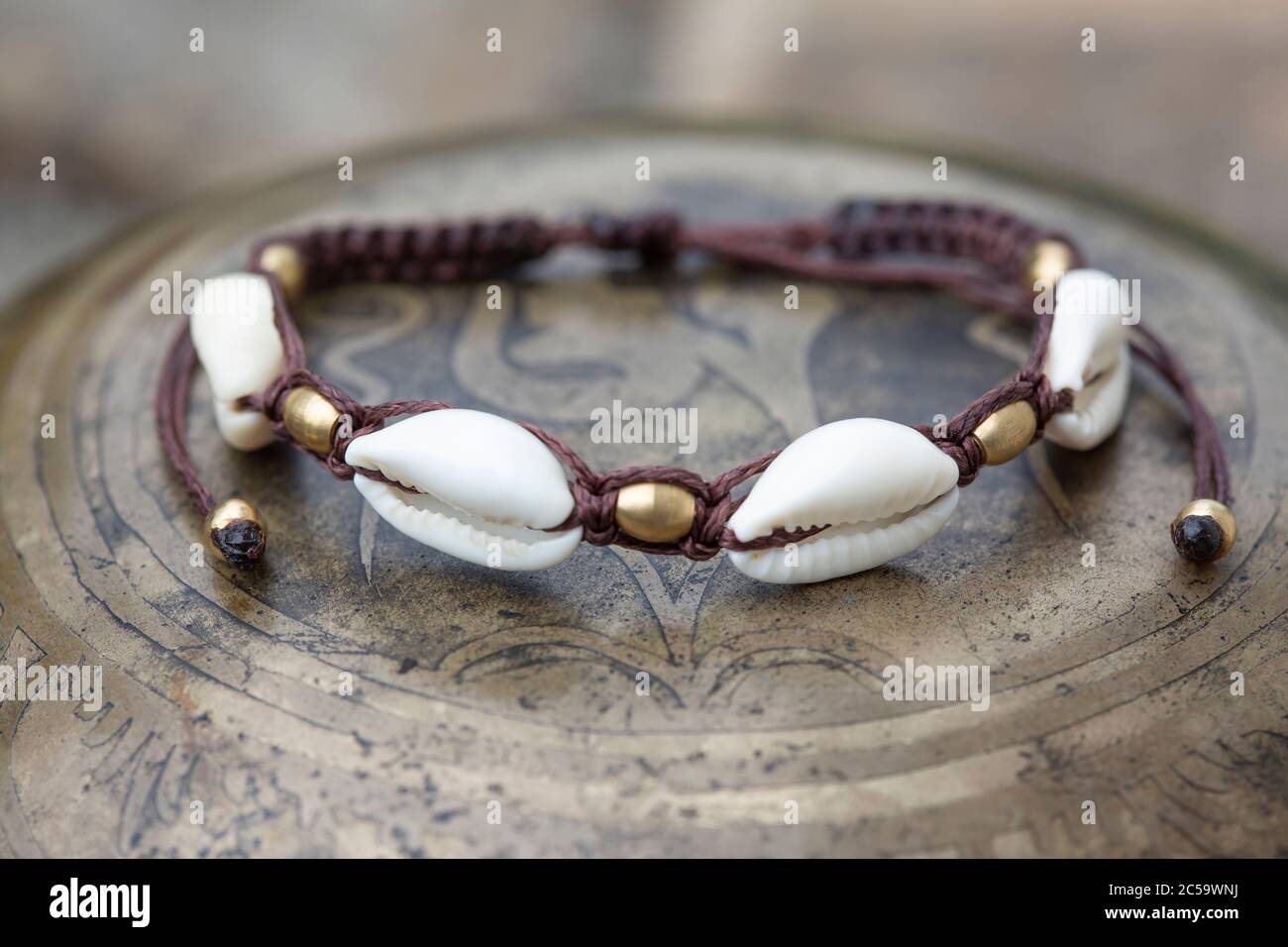 White shell macrame boho bracelet on metal background Stock Photo - Alamy