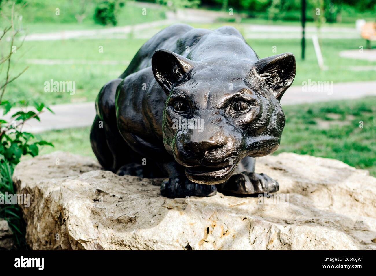 Stone sculpture of a black panther in a park Stock Photo - Alamy