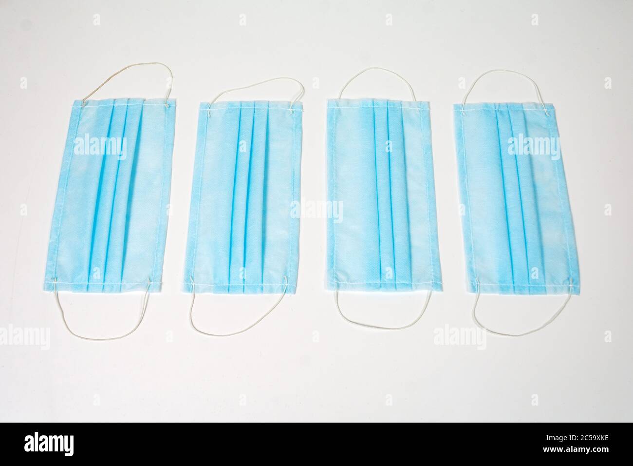 Blue medical masks on a white background Stock Photo - Alamy