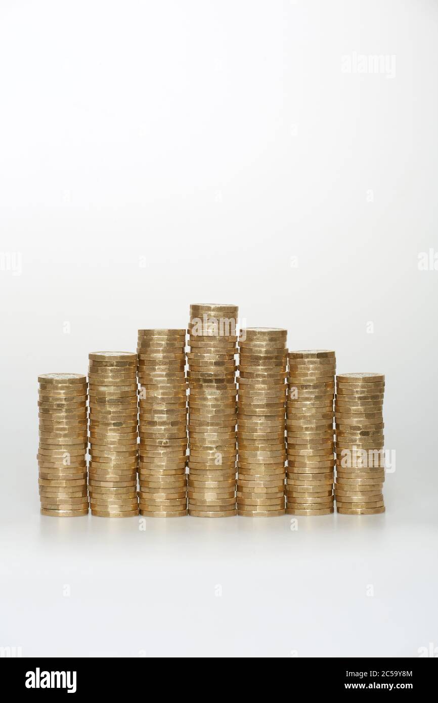 Photograph of stacks of new uk £1 coins which form a house shape.(coins ...