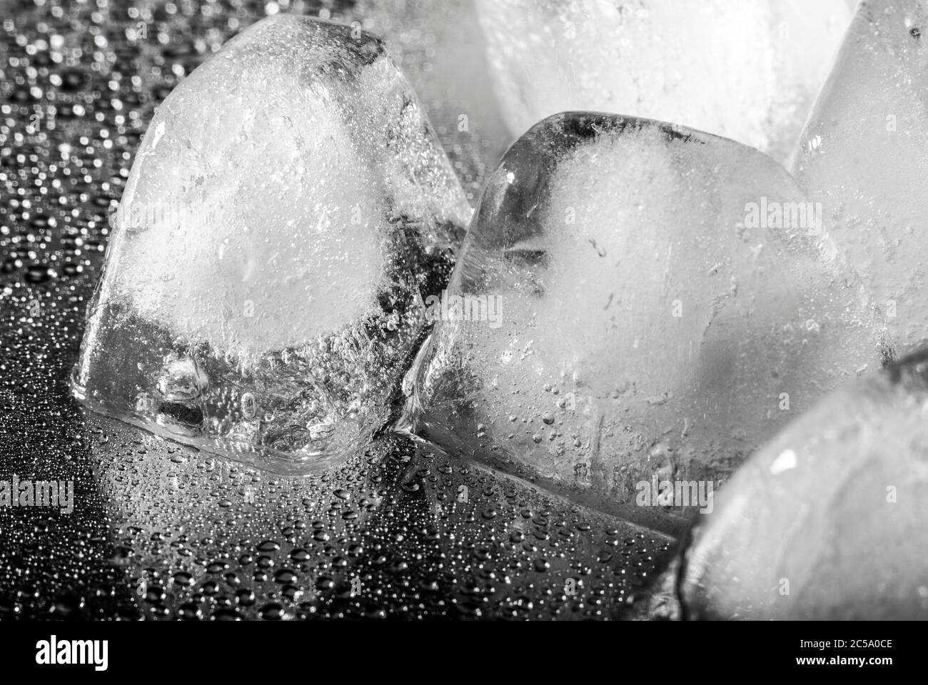 ice cubes reflection on black table background Stock Photo - Alamy