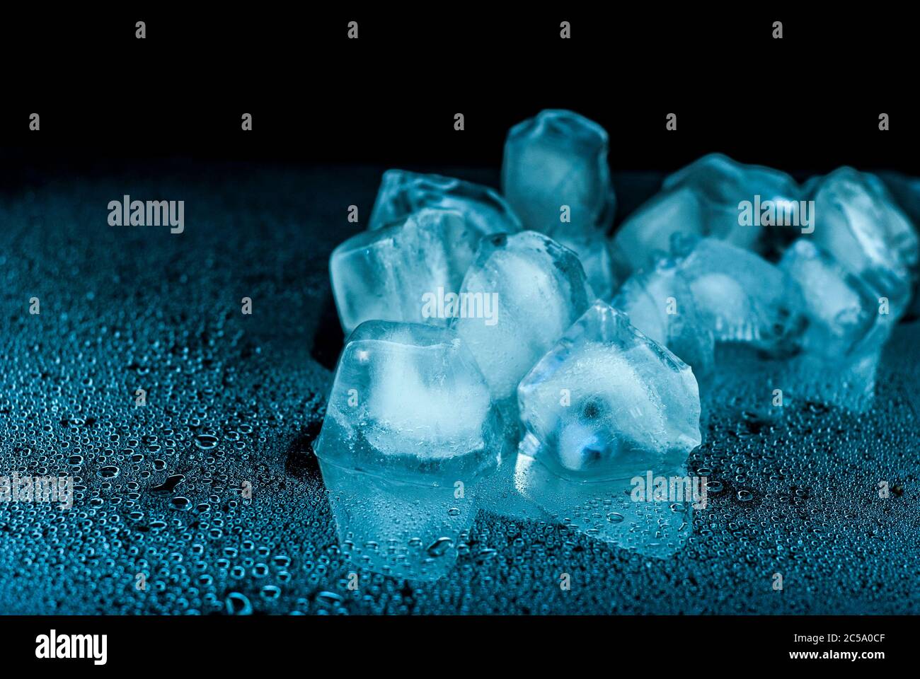 ice cubes reflection on black table background Stock Photo - Alamy