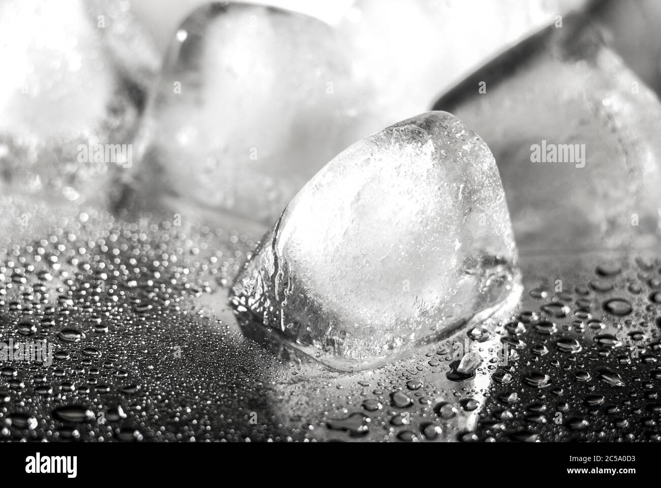 ice cubes reflection on black table background Stock Photo - Alamy