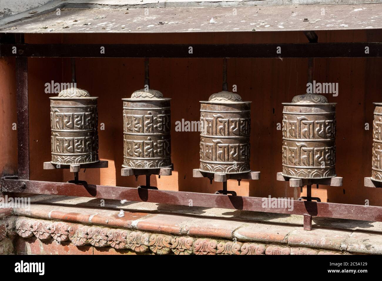 Prayer wheels along the outer perimeter of the Balkumari Buddhist ...