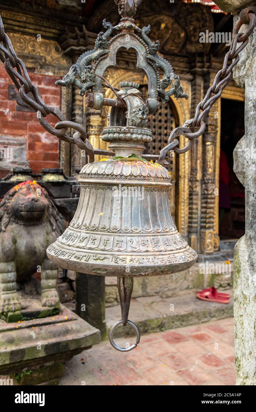 Votive bells placed in front of the entrance of a Buddist Temple ...
