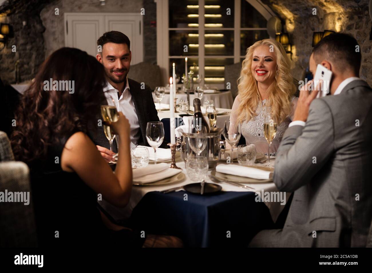 Party, holiday with friends concept. Four people with champagne glasses ...