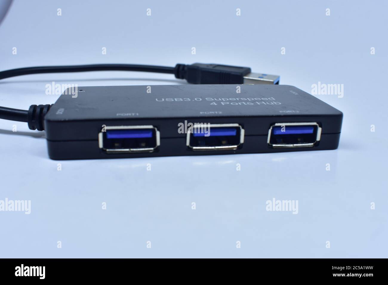 Closeup of a black portable USB hub with a wire isolated on white ...