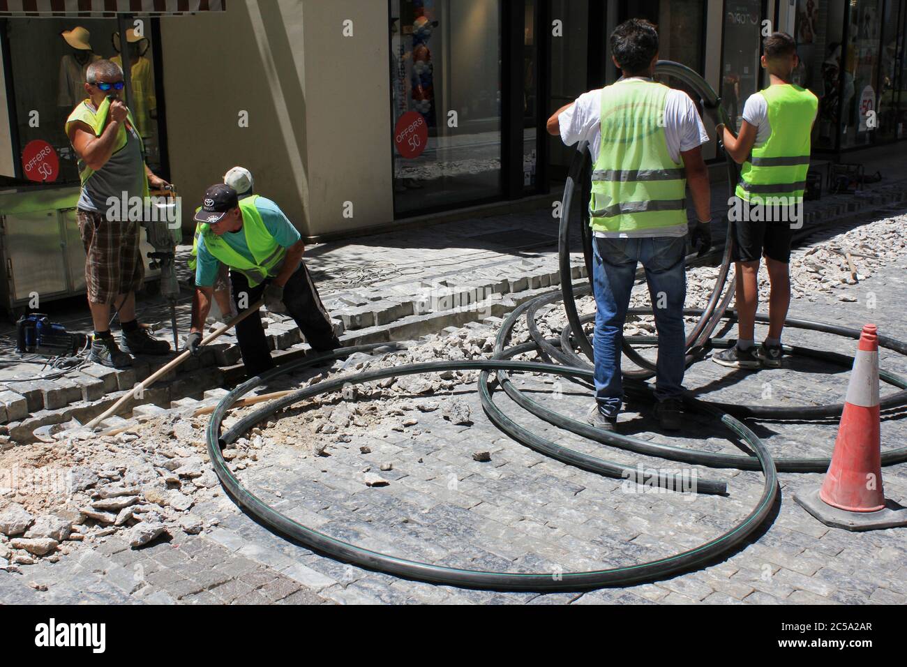 Greece, Athens, June 28 2020 - Construction workers digging and paving ...