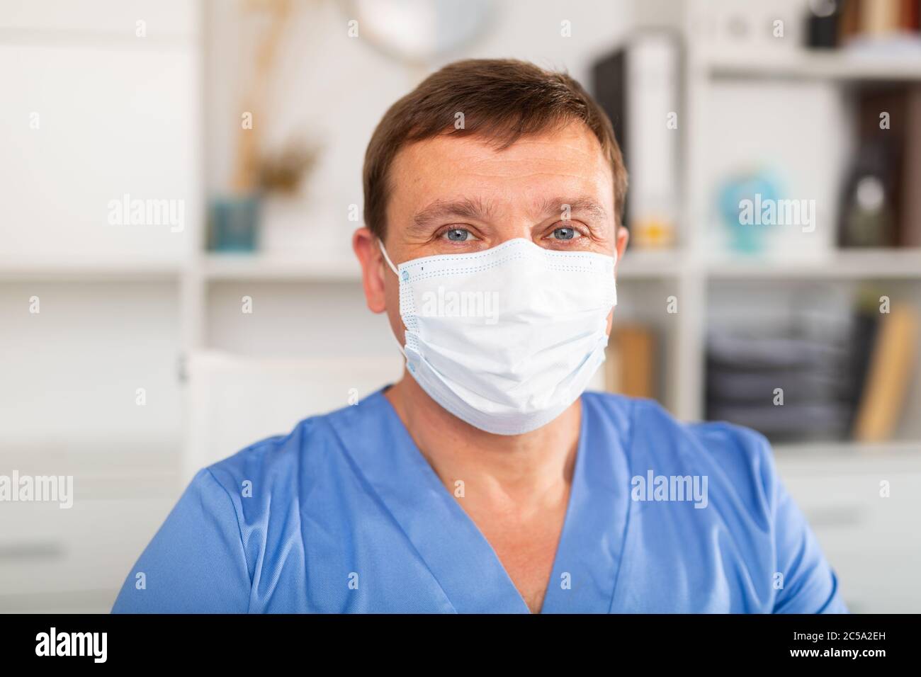 Close up portrait of male doctor wearing disposable face mask in ...