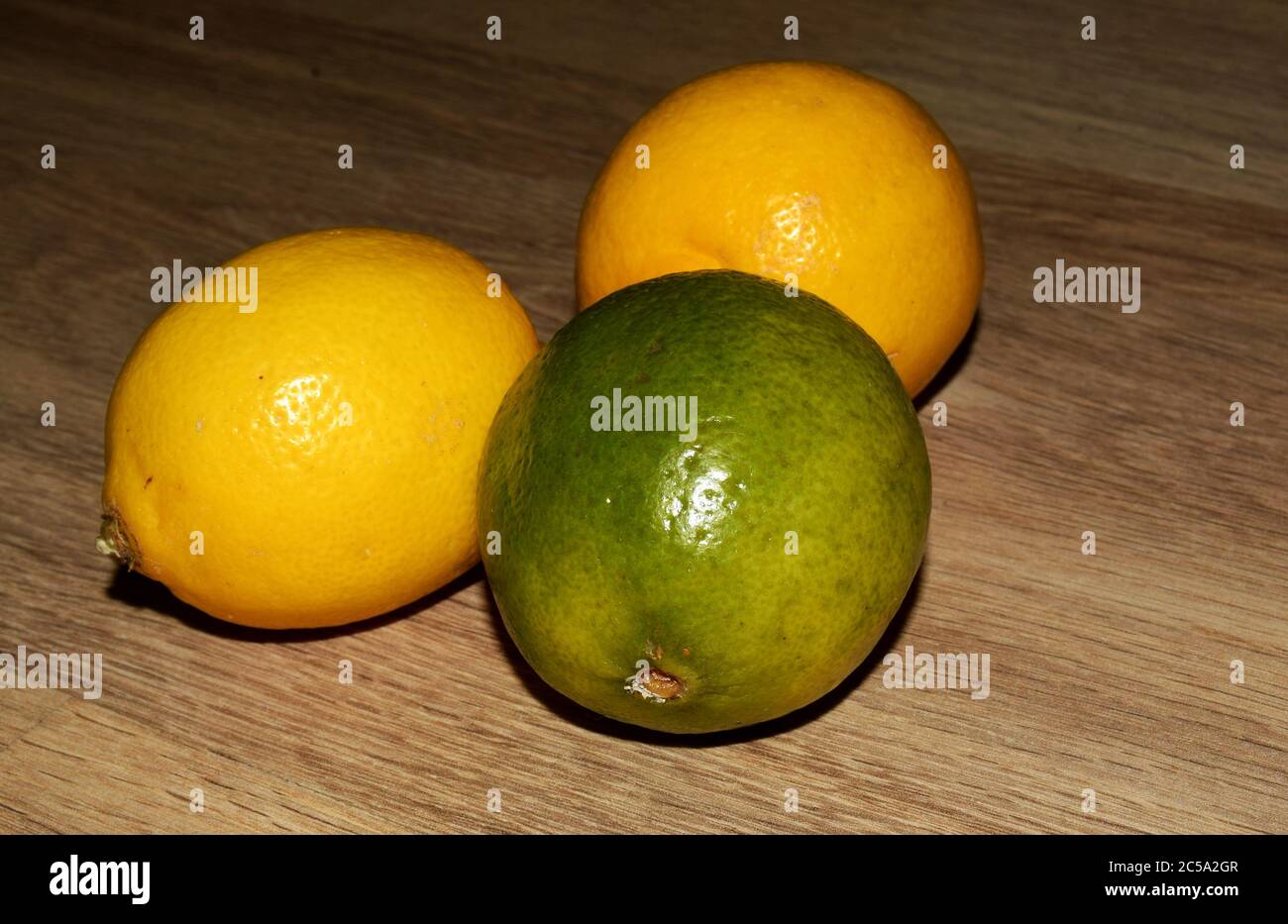 lemon and lime on wood board background Stock Photo - Alamy