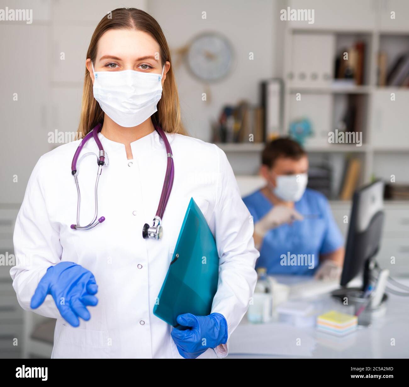 Portrait of female doctor in lab coat and protective medical masks ...