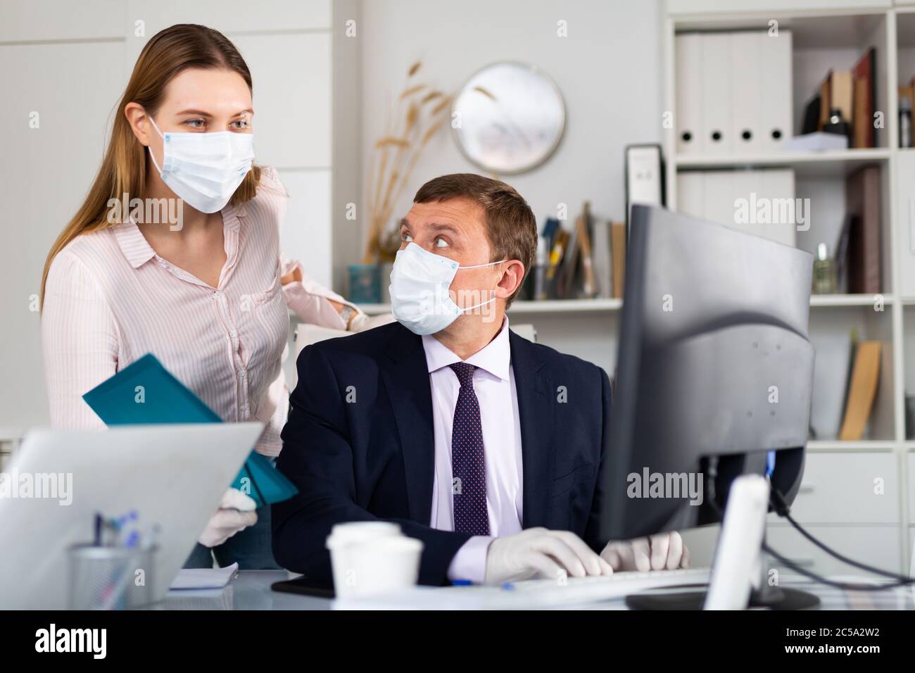 Director gives instructions to secretary in office Stock Photo - Alamy