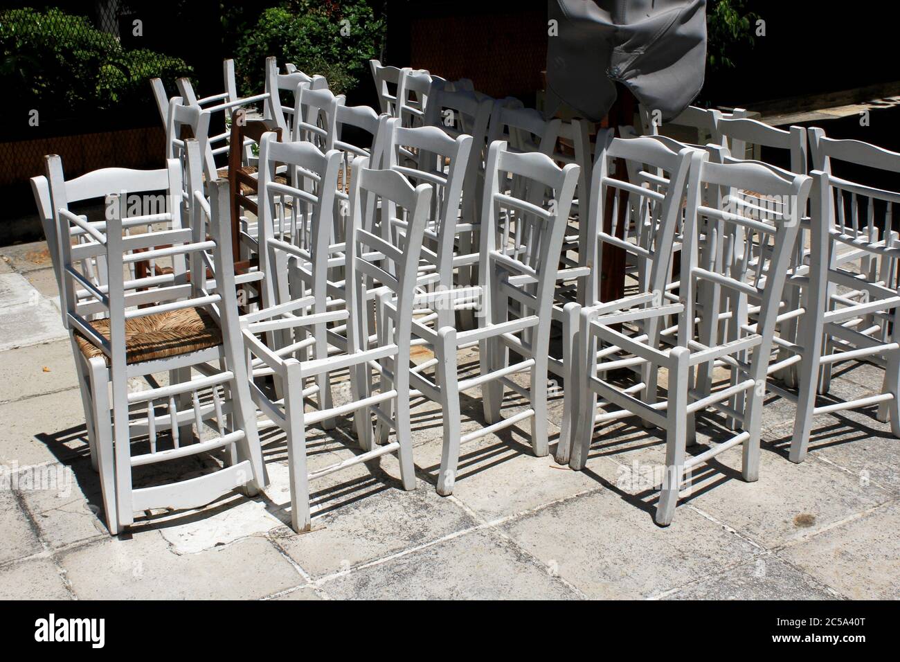 Greece, Athens, June 28 2020 - Chairs stacked outside of a traditional ...