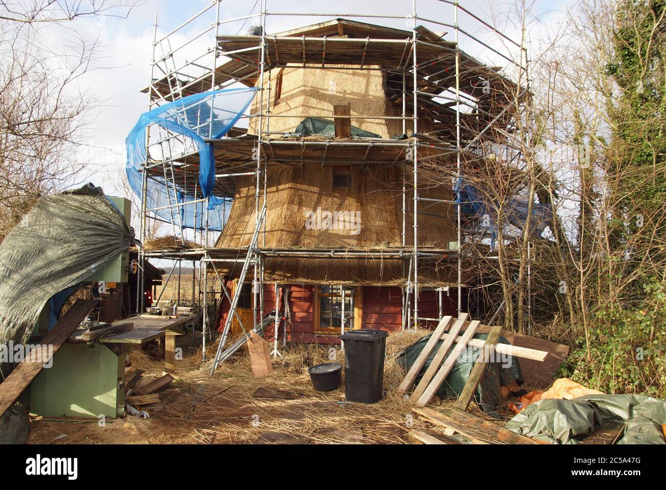 Old thatched windmill in the Netherlands. Being restored. Without hood ...