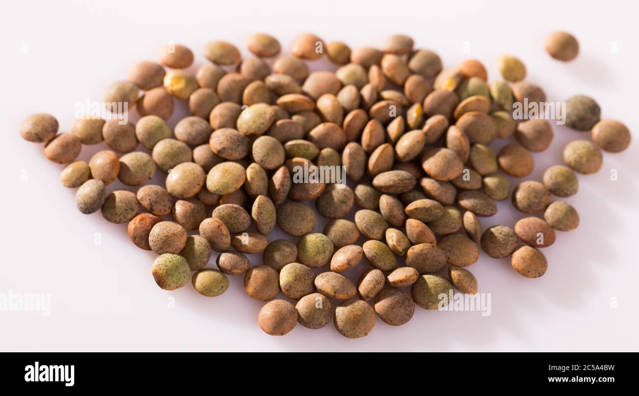 Pile of raw lentil grains on white background. Organic food for healthy eating Stock Photo - Alamy