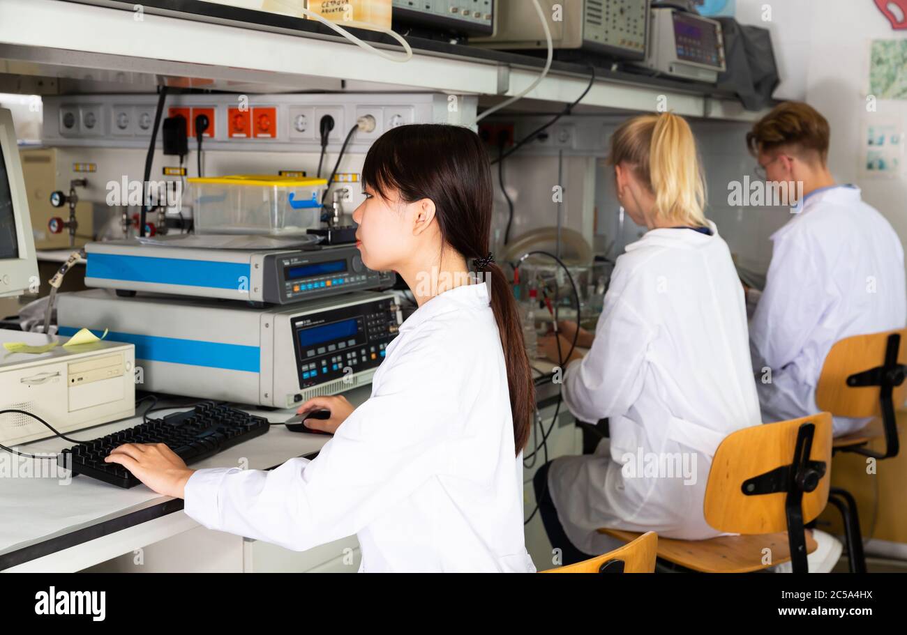 Portrait of young Chinese woman lab technician engaged in research in ...