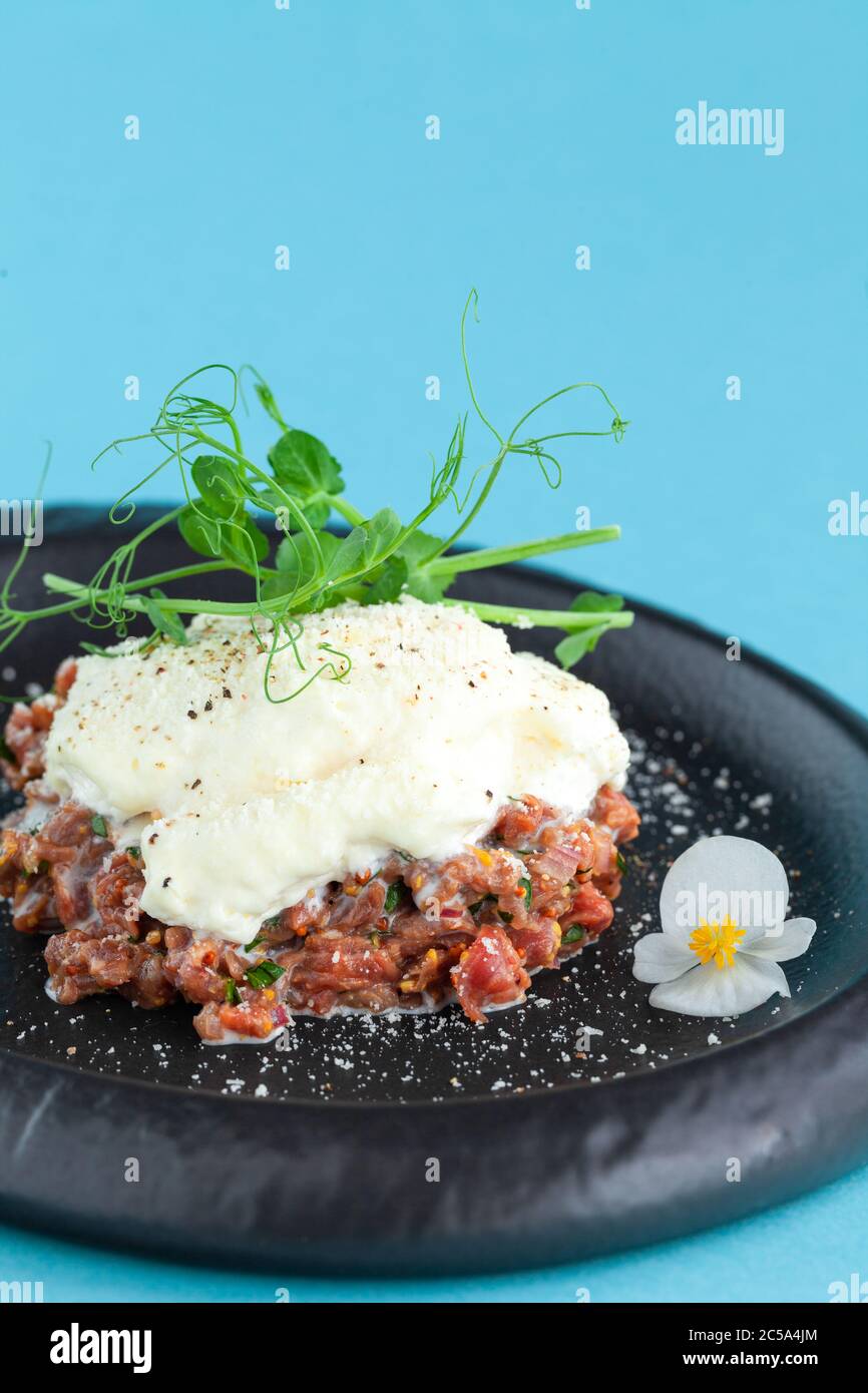 Portion of appetizer tartar made from chopped fresh beef, parmesan ...