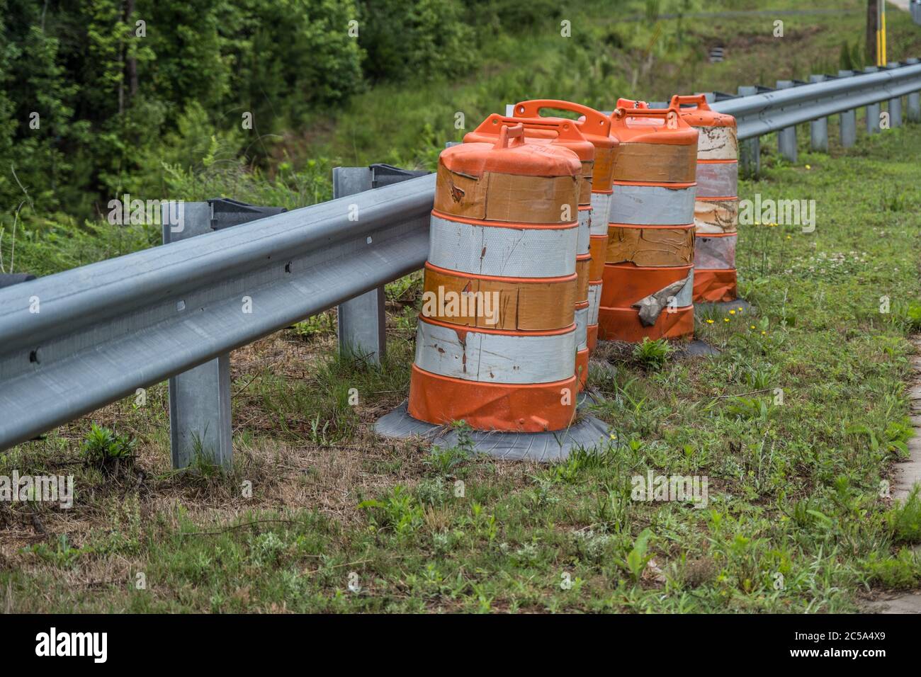 Several construction barrels tattered and grungy left abandoned ...