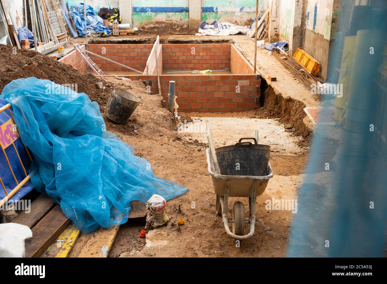 View of empty building site with brick construction, tools and ...
