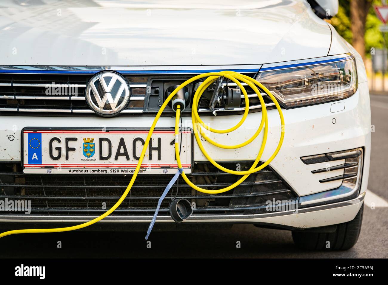 Modern electric cars EV Car plugged into charging station in city. New ...