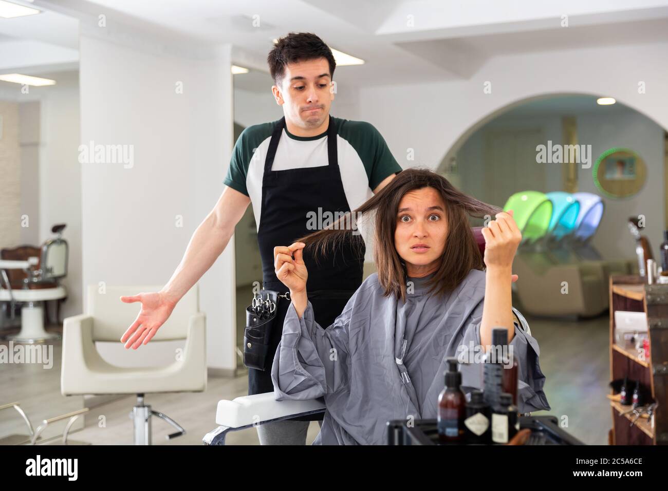 Displeased woman client after haircut having conflict with guy ...