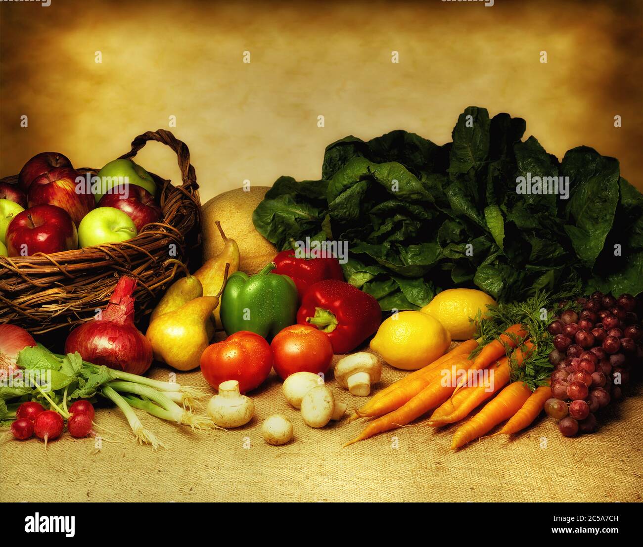 Fresh Produce on burlap still life with warm side light. An array of ...