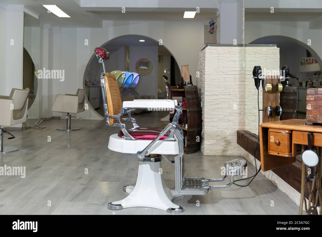 Interior of modern light beauty salon, empty space with chairs and hair ...