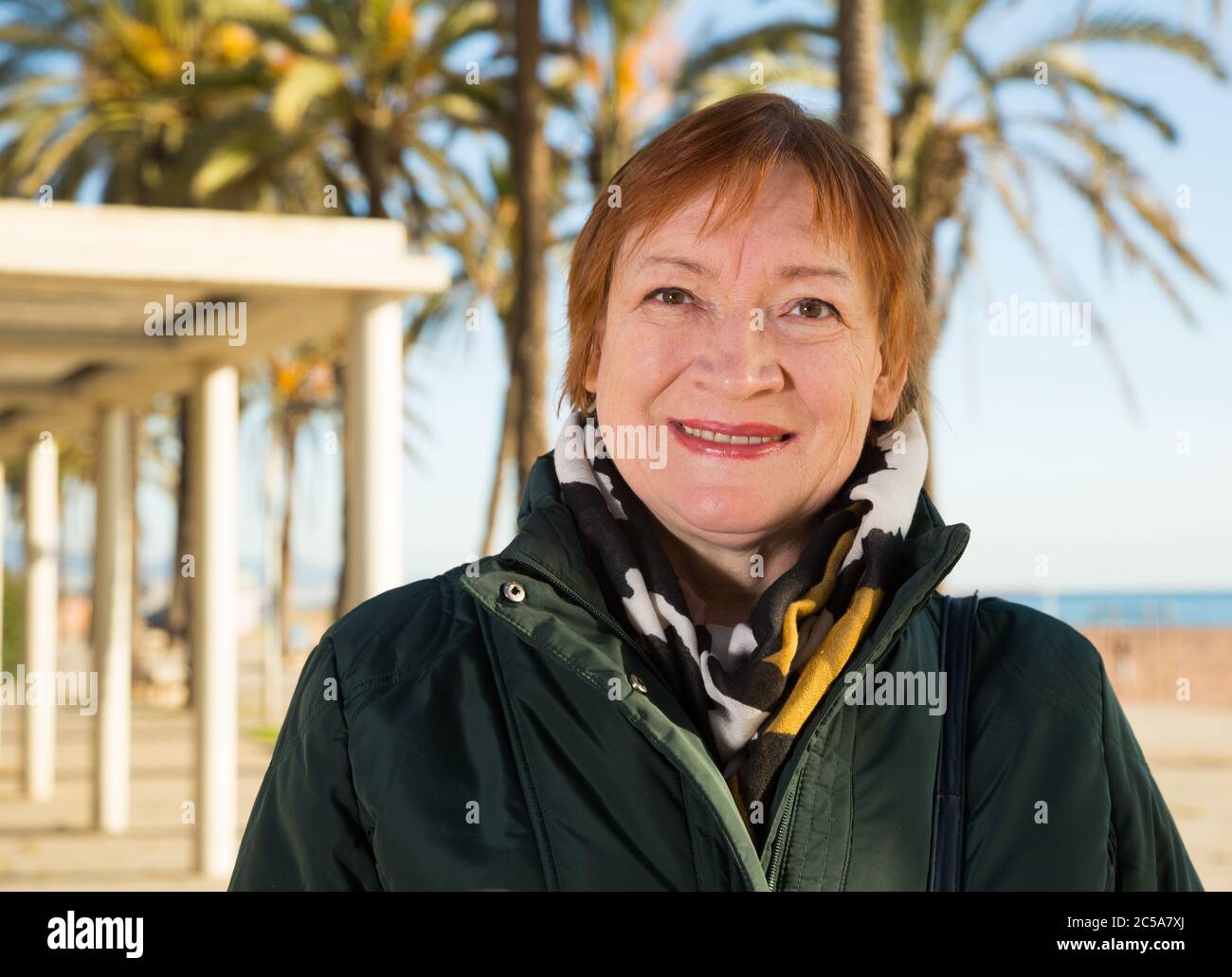 Closeup portrait of stylish mature woman strolling along city ...