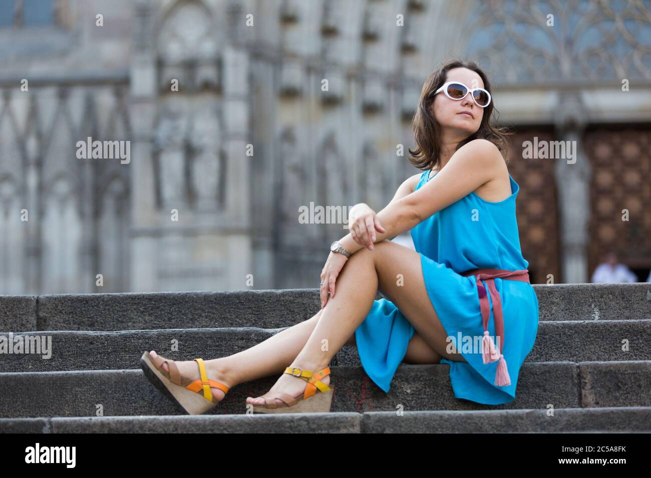 Beautiful girl sitting on curb hi-res stock photography and images - Alamy