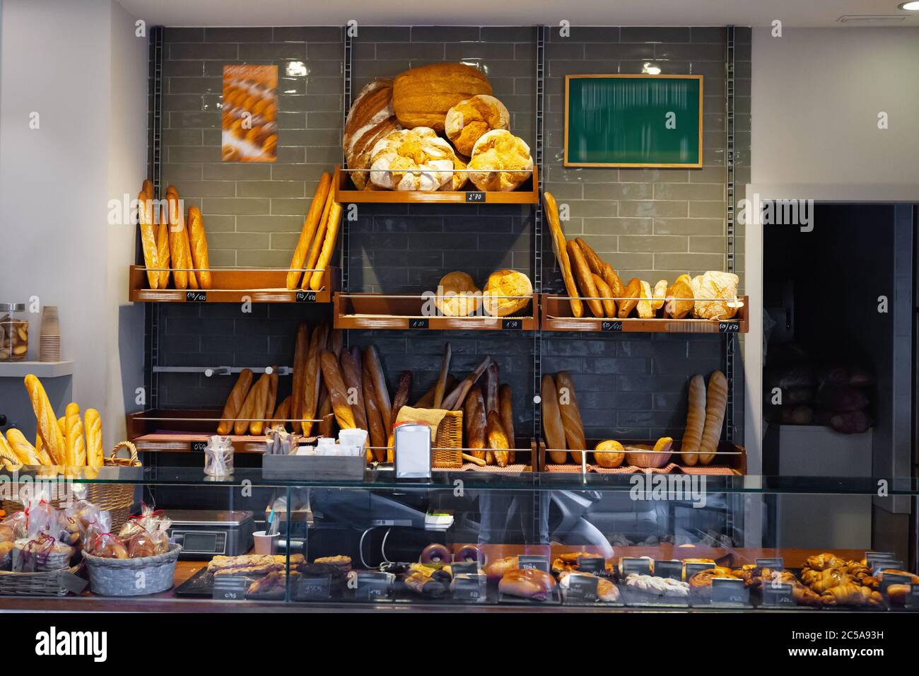Interior of small Spanish bakery shop with racks and showcase full of ...