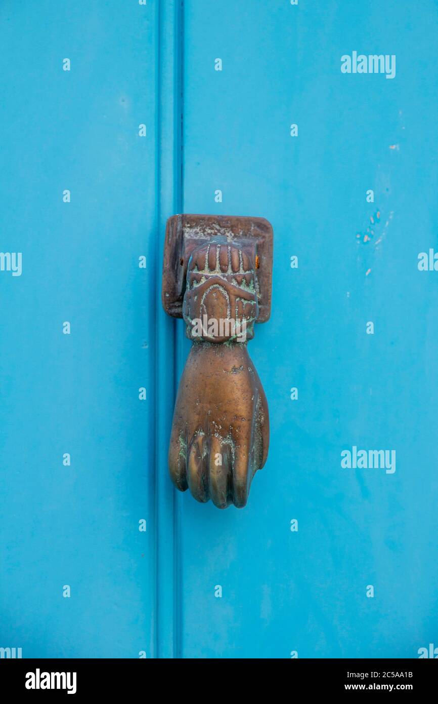 SKIATHOS, GREECE - AUGUST 13, 2019. Brass knocker on traditional house ...