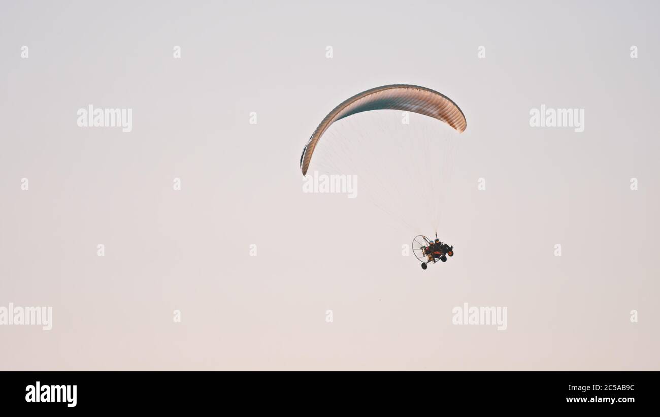 Paramotor Tandem Gliding And Flying In The Air. Copy space. High ...