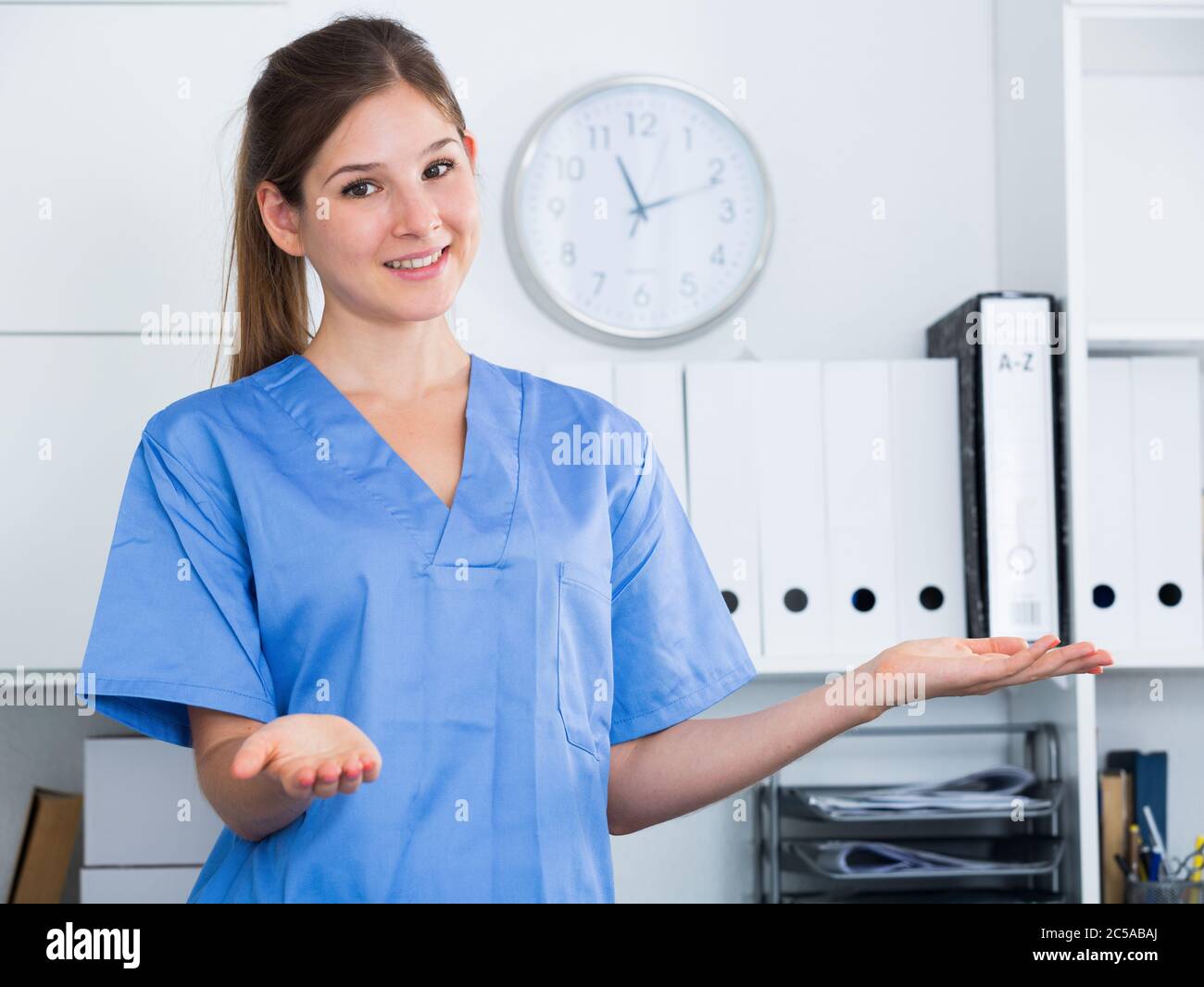 Female doctor making welcome gesture, politely inviting patient in ...