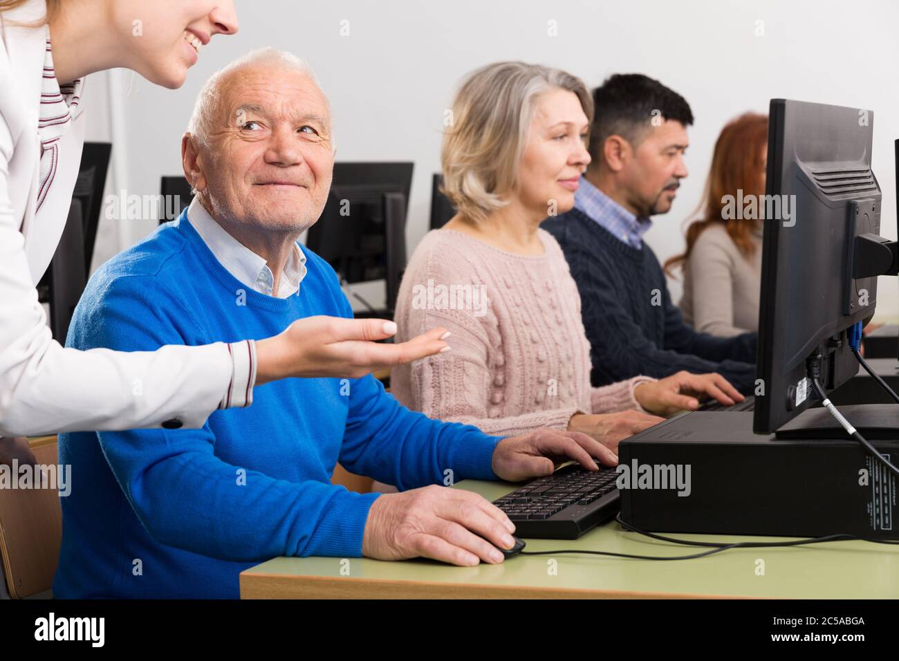 Portrait of smiling senior man during computer classes for elderly ...