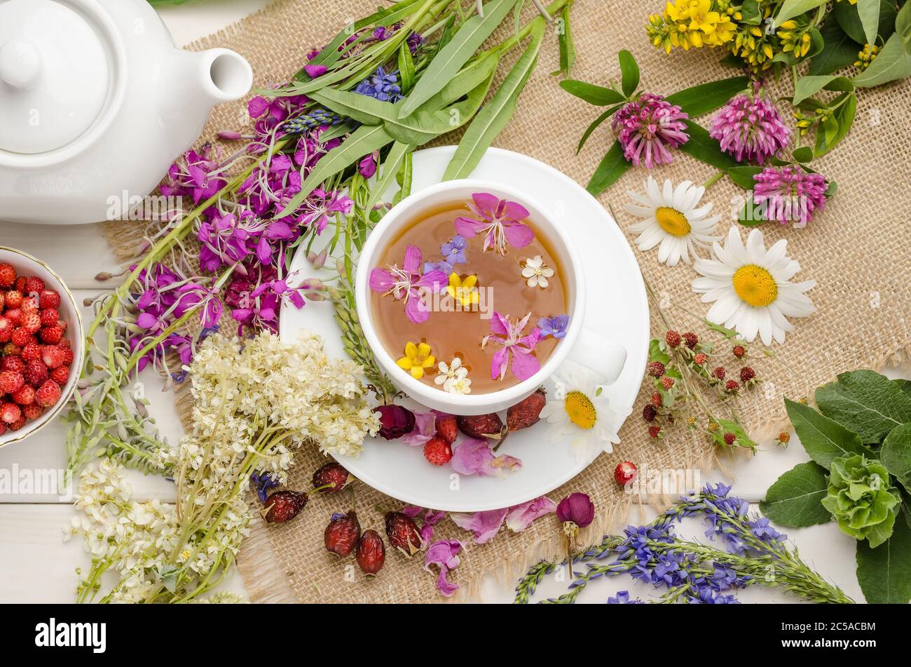 Herbal tea in a white cup with flowers. Tea ceremony. Tea with ...