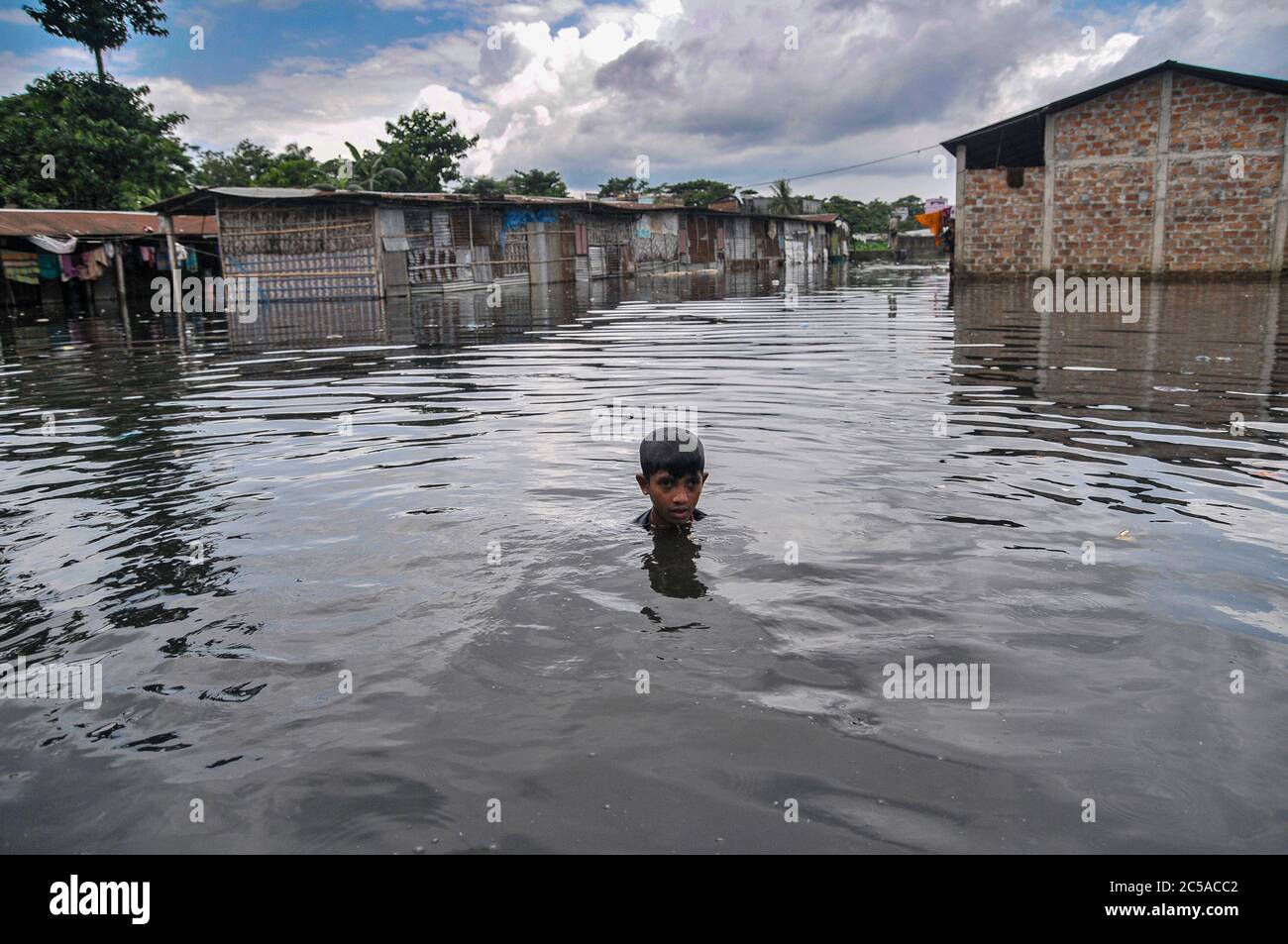 A little boy is in flood water in a slum of kamalgor. Nearly 2.5 lakh ...
