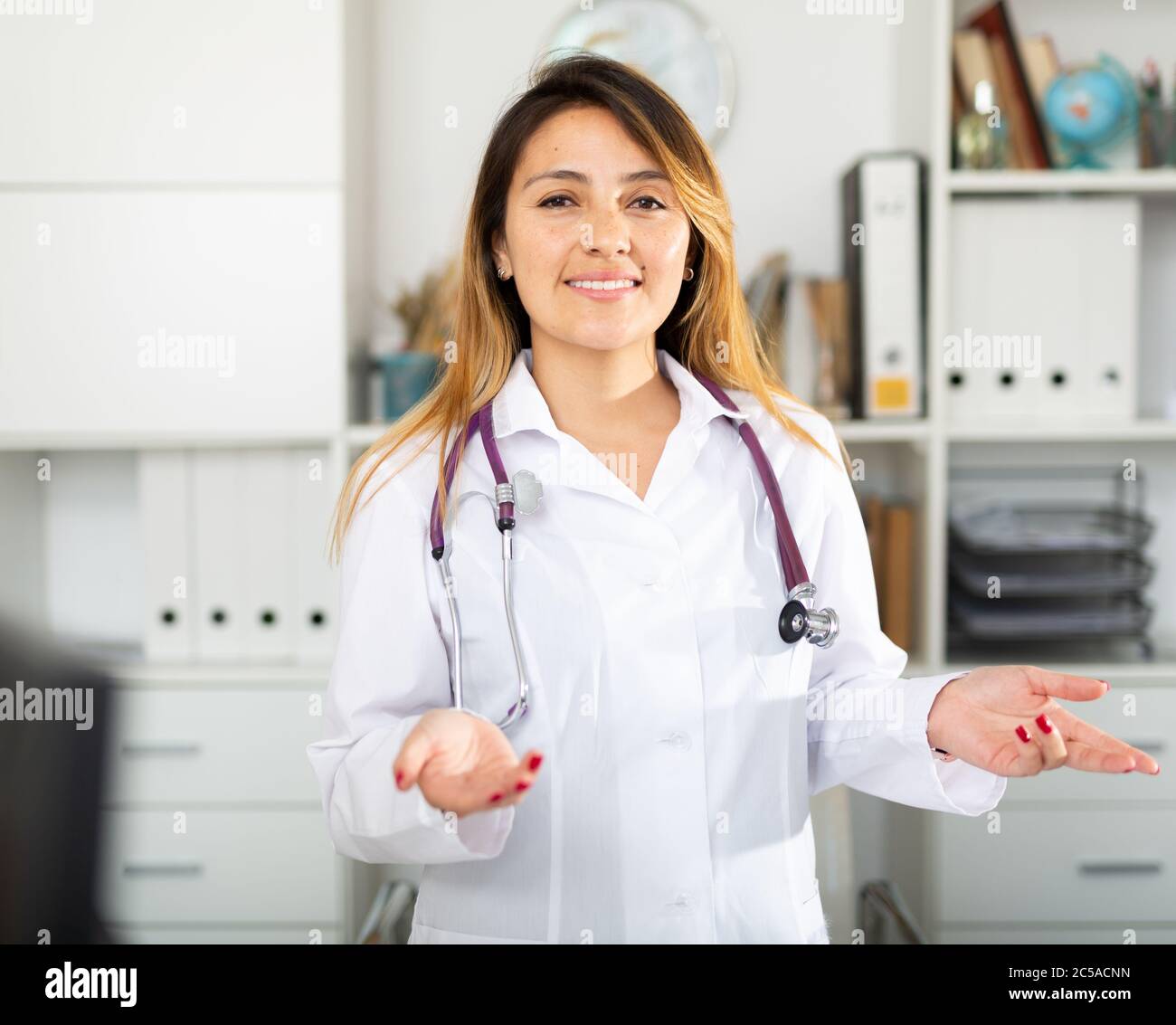 Young mexican female medic in uniform standing in doctor's office Stock ...