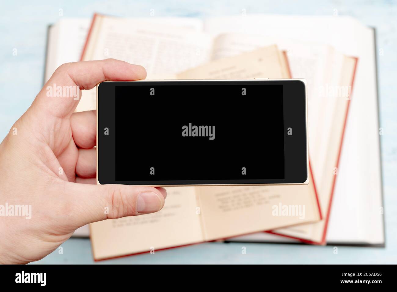 Smartphone in mans hand. Modern gadget phone. Phone screen. Old paper ...