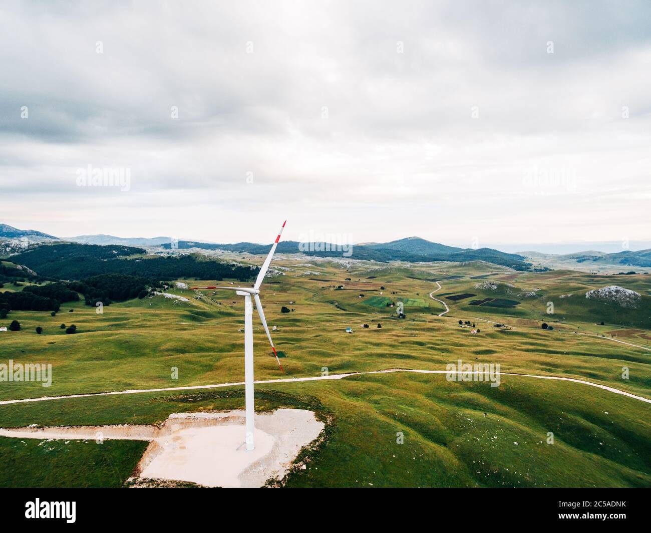 A huge wind farm with three blades on the green hills in Montenegro ...