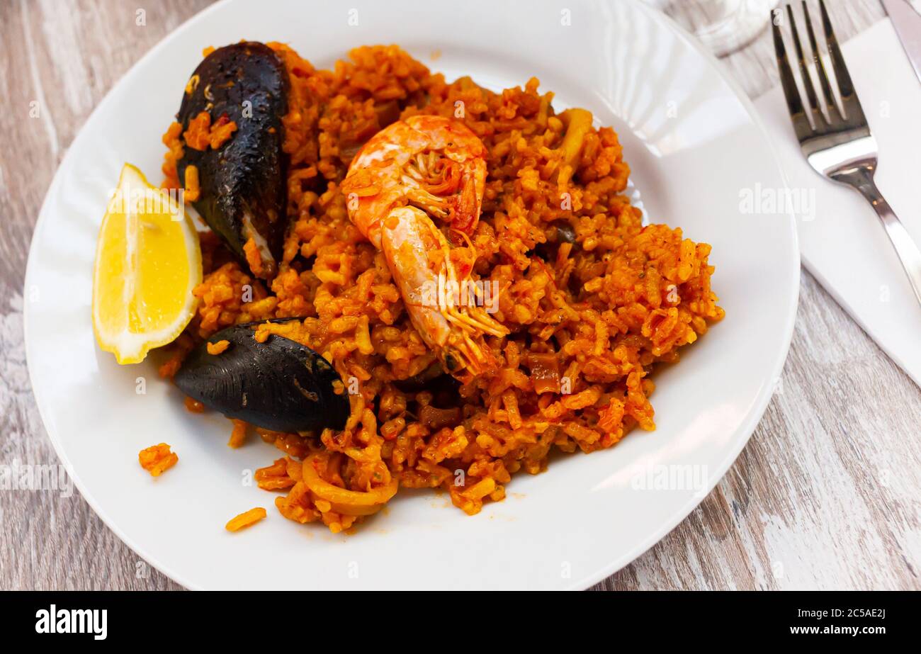 Traditional Valencian paella de mariscos with shrimps and mussels ...