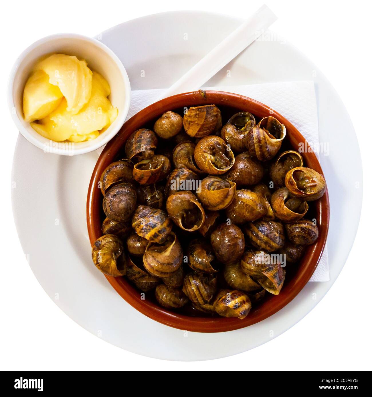 Picture of tasty baked snails in bowl, served with bread and butter ...