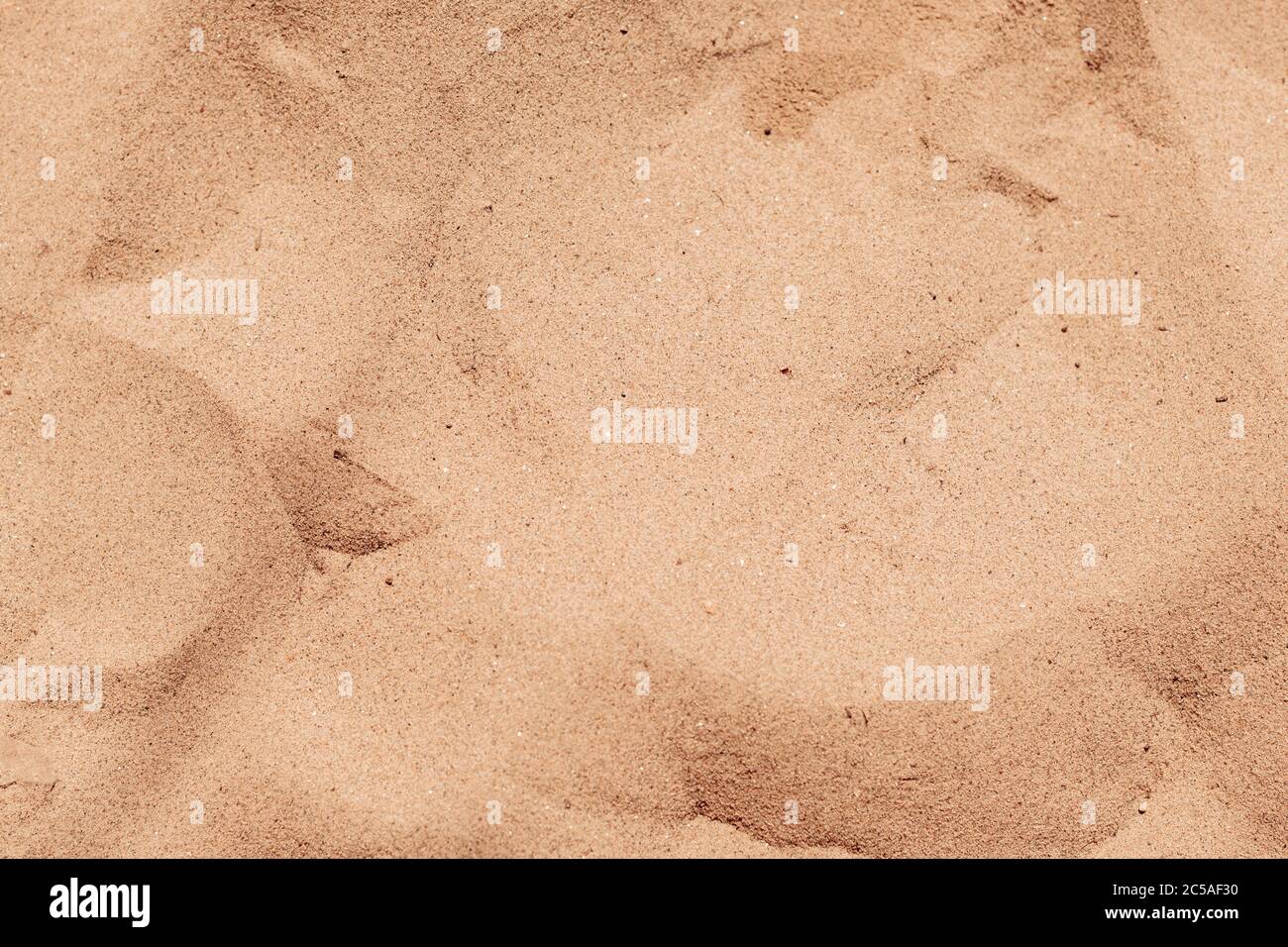 Texture of warm beach sand top view as summer vacation season ...