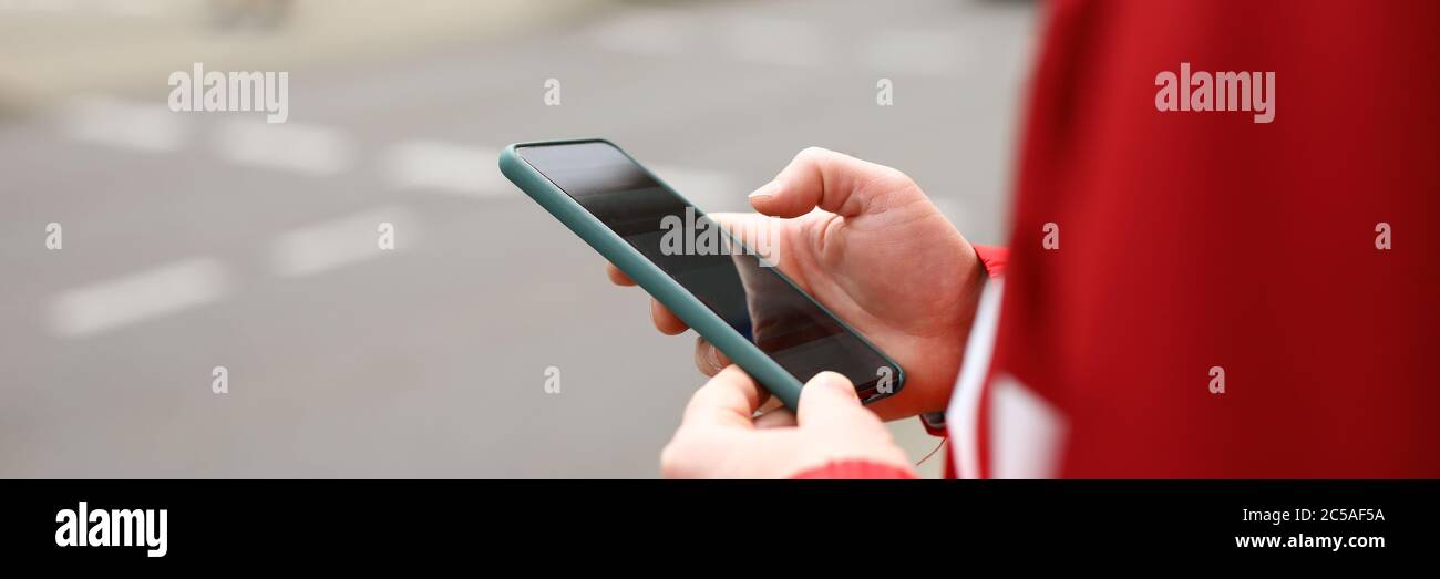 Man stands at crossroads with phone in his hands Stock Photo - Alamy