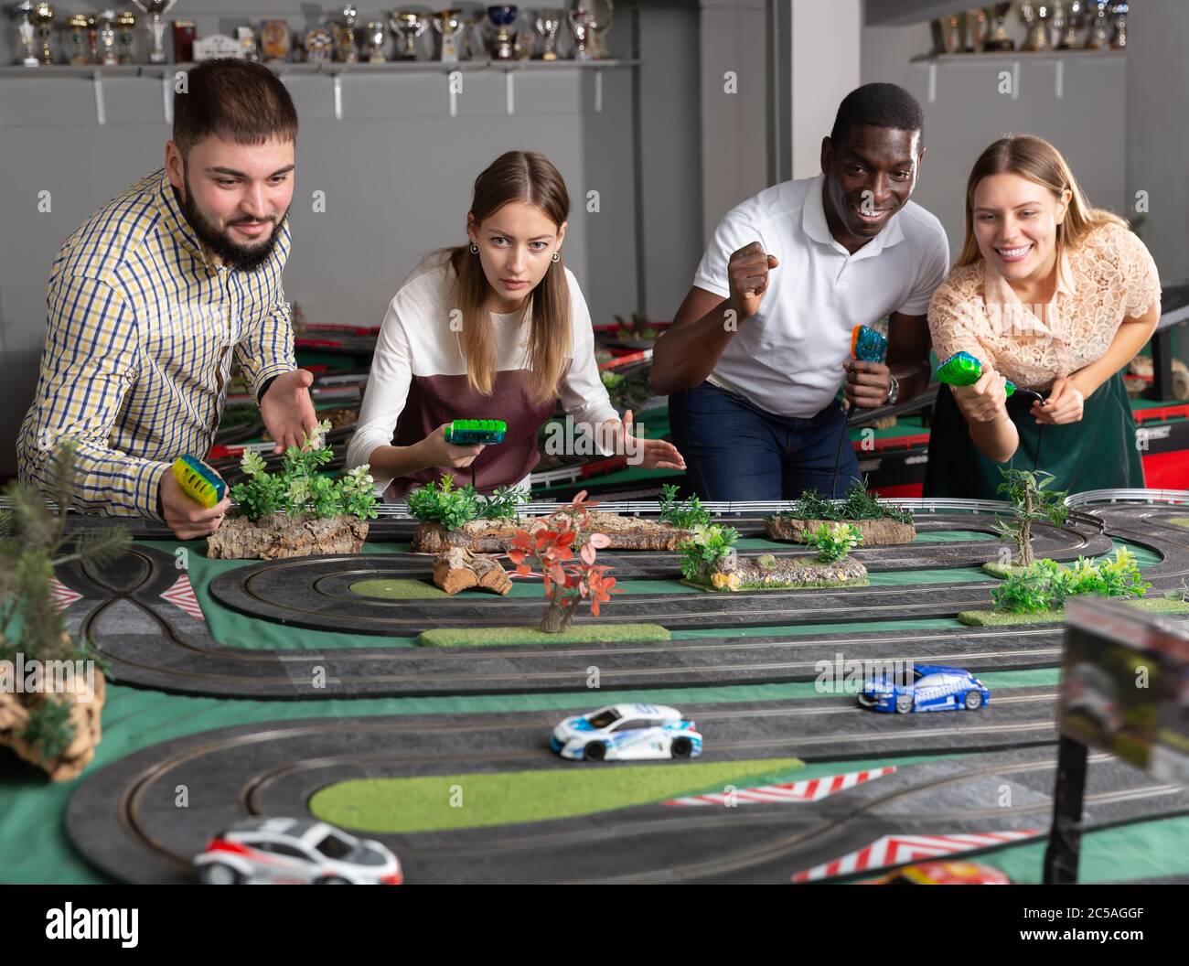Racing car on the toy race track and emotional team players Stock Photo ...