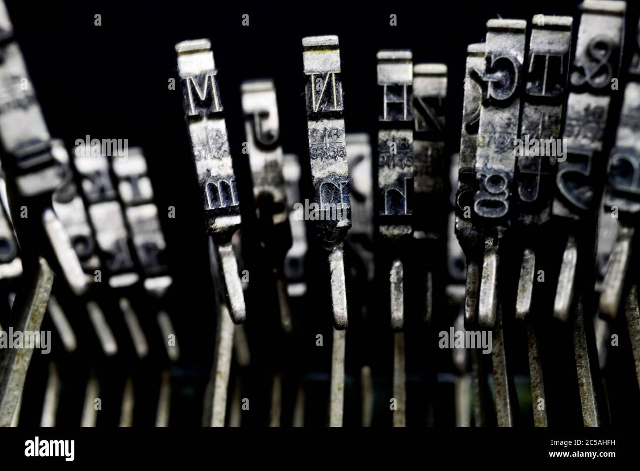 Macro closeup of isolated type bars of old typewriter with letters and ...