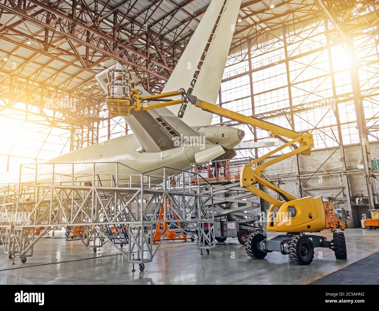 Aircraft service, view of the tail of the aircraft and a crane with a ...