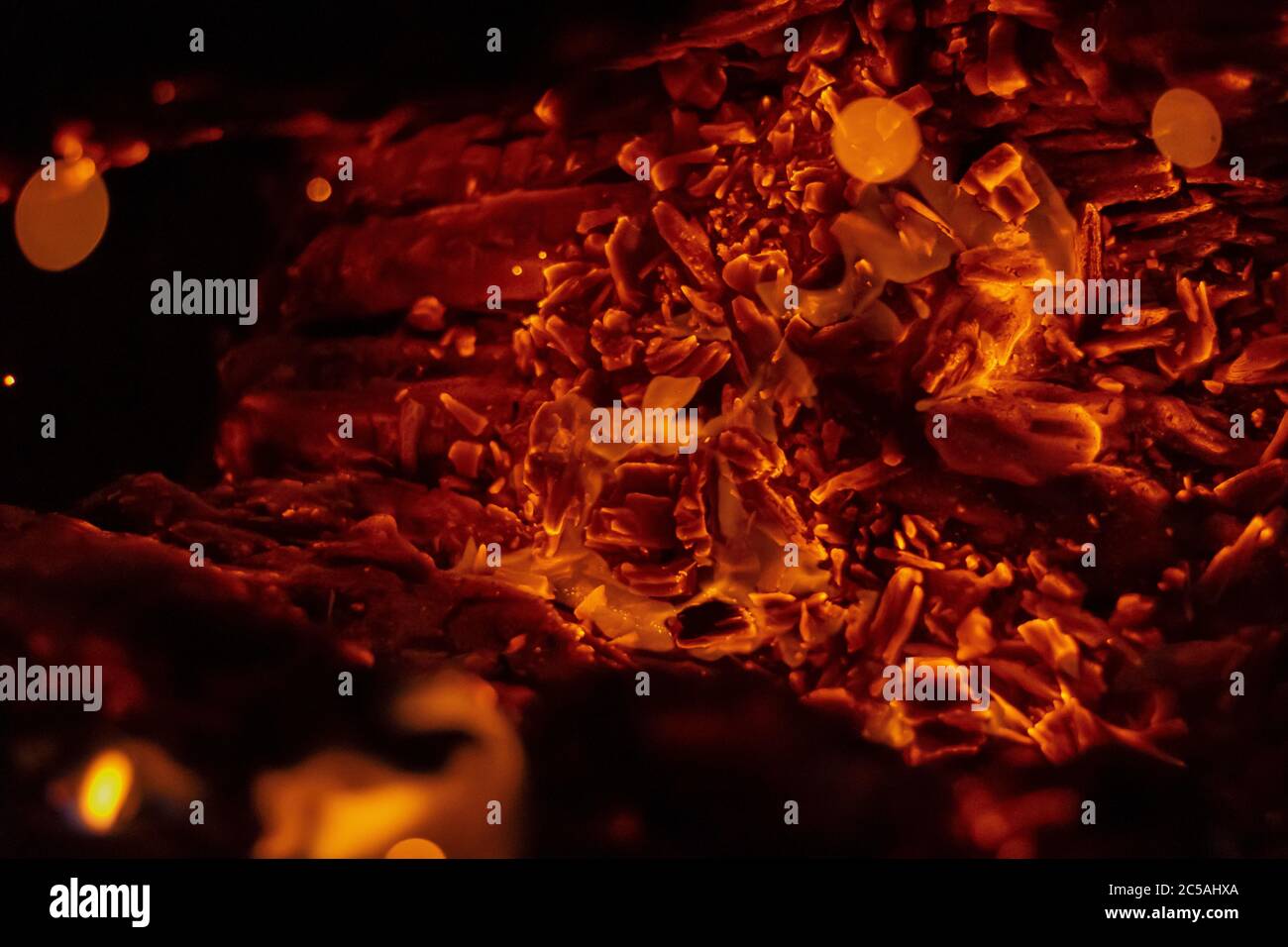 Closeup of embers of a burning log creating a fiery background Stock ...